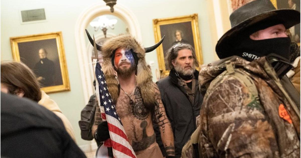 Jan. 6 political theatre: video shows police leading QAnon Shaman ...