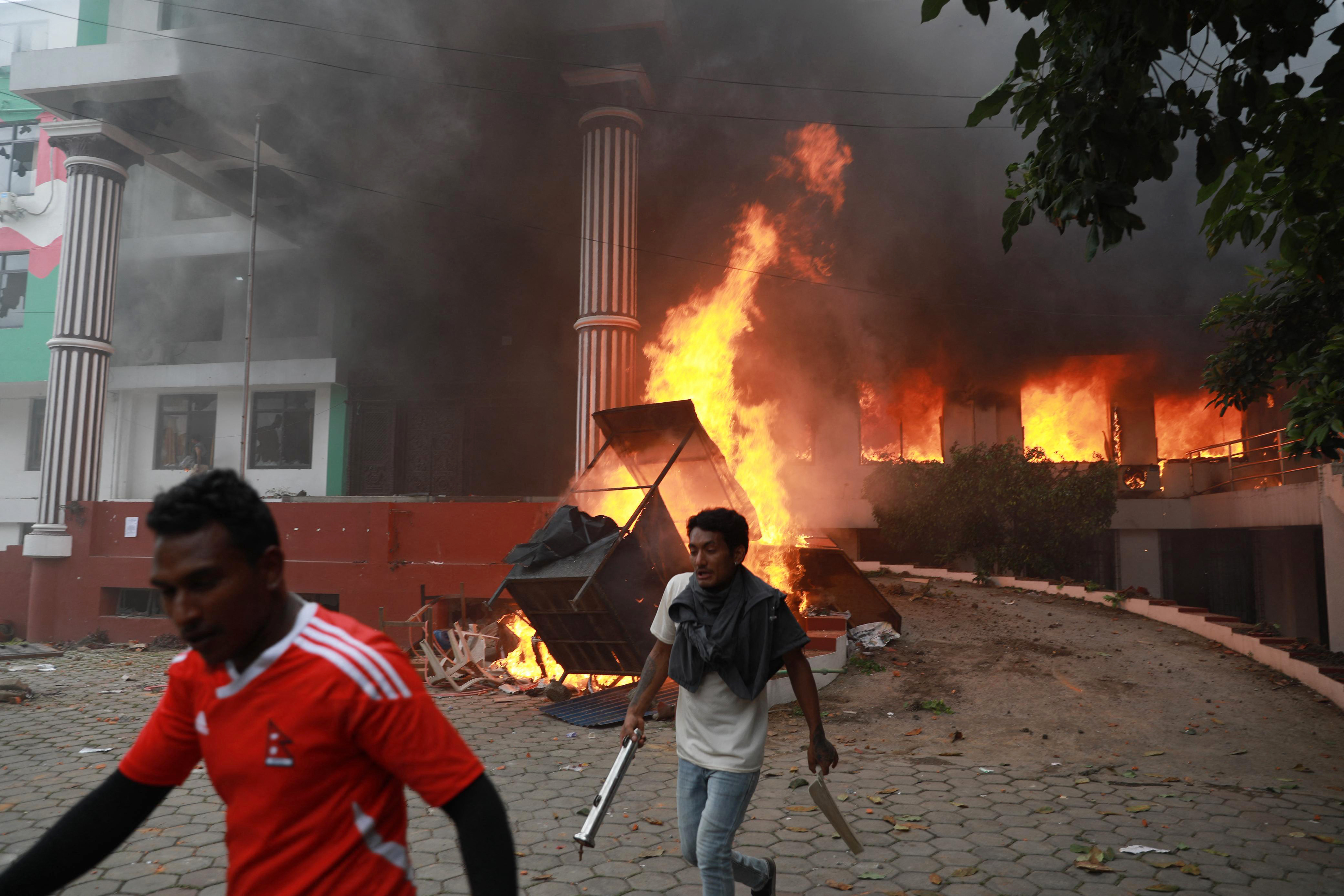Nepal: Protesters set fire to parliament after prime minister's resignation